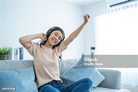 아시아의 재미있는 여자는 음악을 듣고 거실에서 바닥에 춤을 매력적인 아름다운 어린 소녀는 집에서 여가 시간을 보내고 집에서 주말 활동을 즐기는 행복한 헤드폰 을 착용 일본