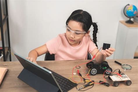 Premium Photo Asian Littlle Girl Constructing And Coding Robot At Stem Classfixing And Repair