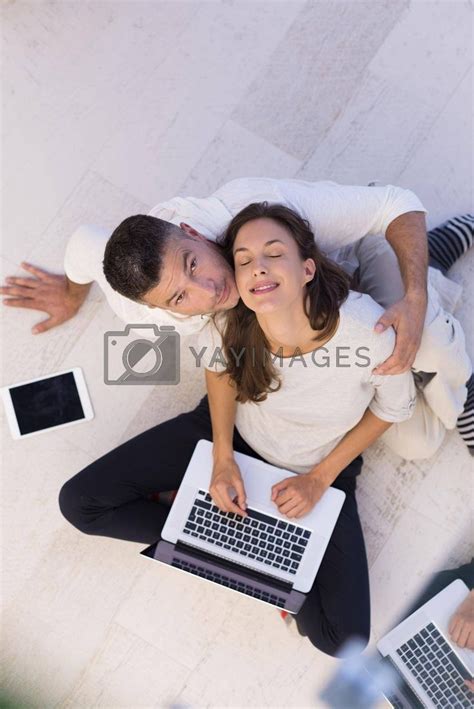 Couple Using Tablet And Laptop Computers Top View