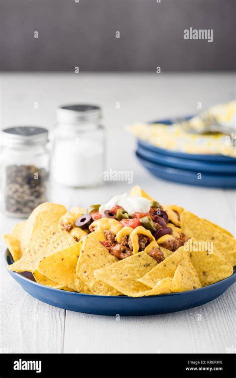 Beef Nachos With Jalapeno Olives Tomato Beans Cheddar Cheese And