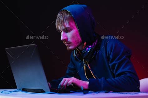 Hacker It Genius Using Laptop Writing Code Wearing Hood On Head Cyber Security Concept Stock