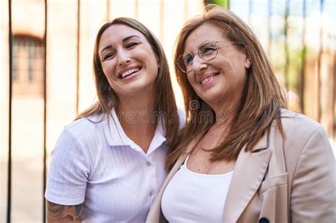 Mother And Daughter Smiling Confident Standing Together At Street Stock