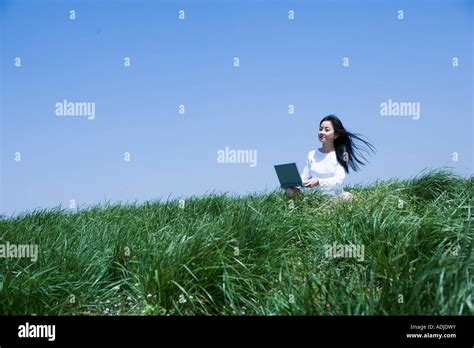 A Woman Doing Something With A Notebook Stock Photo Alamy