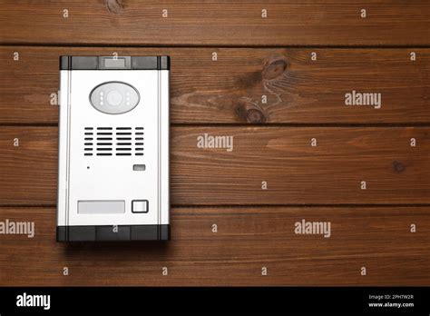 Modern Intercom System With Camera On Wooden Background Top View