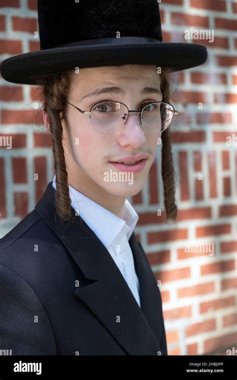Head And Shoulders Portrait Of A Hasidic Teenager With Long Curly Peyot In Williamsburg