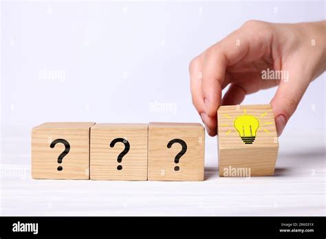 Idea Concept Woman Putting Cube With Illustration Of Light Bulb To Other Ones With Question