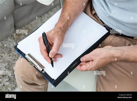 Man Writing On Notepad Stock Photo Alamy