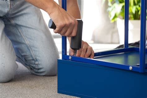 Diy Furniture Assembly At Home With Cordless Drill In Modern Living Room Instructions Stock