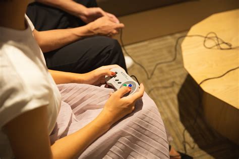 Unrecognizable Couple Playing Video Game With Gamepads At Home · Free