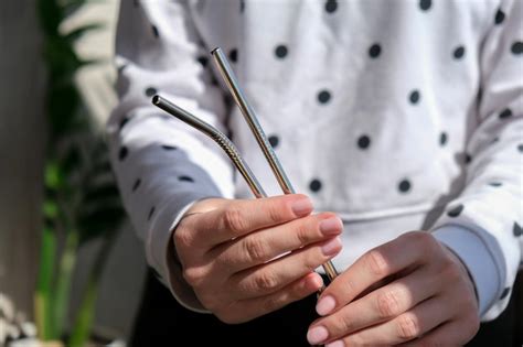 Premium Photo Woman Holding Reusable Metal Straw Female Hand On Reusable Collapsible Drinking