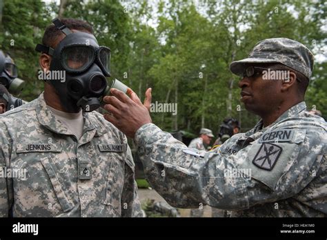 A Us Army Cbrn Specialist Inspects A Soldiers M40 Protective Mask