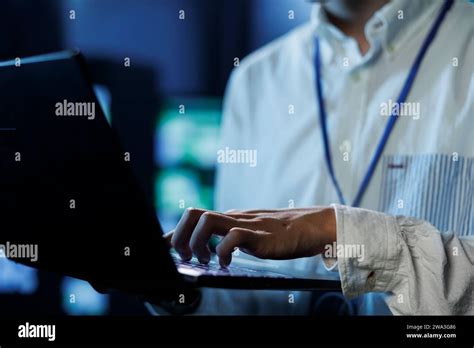 Man Between Server Hub Rows Providing Processing Resources For Businesses Worldwide Blurry