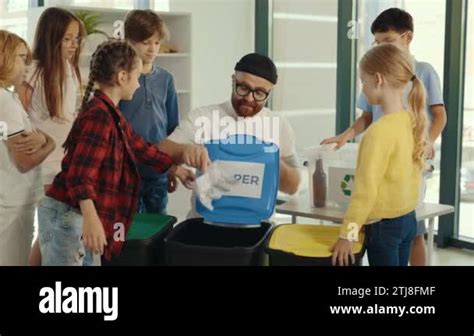 Male Teacher Teach Where To Sort The Rubbish Garbage Sorting Class