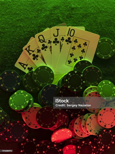 녹색과 빨간색 네온 조명 아래 검은 배경에 대해 재생 테이블의 녹색 커버에 누워 로얄 플러시 와 칩의 클로즈업 상단보기 사진 가능성에 대한 스톡 사진 및 기타 이미지