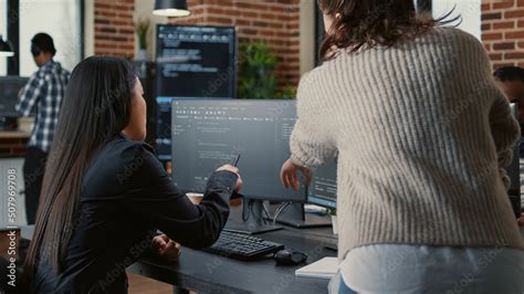 Programer Pointing Pencil At Computer Screen With Software Compiling Code Explaining Source