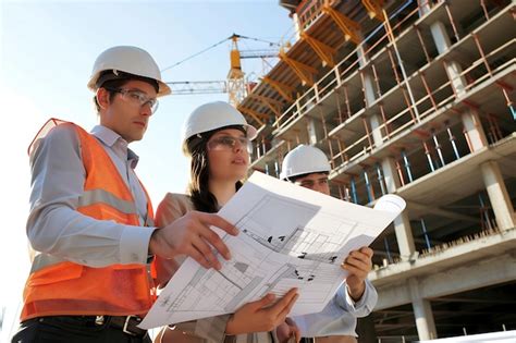 Engineers Architects Reviewing Blueprints Team Discussing Construction Plans Premium Ai