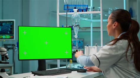 Researcher Looking At Chroma Key Display In Modern Equipped Lab At Night Team Of