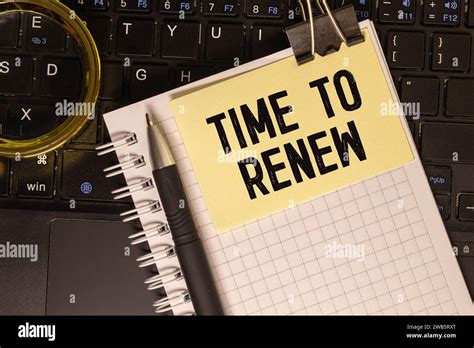Time To Renew Notepad Writing On The White Background With Alarm Clock