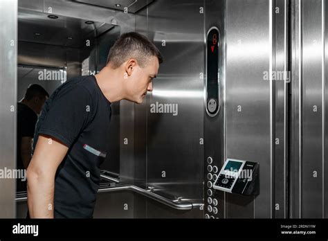 A Man Shows His Face To A Fingerprint Access Control Terminal With A Facial Recognition Function