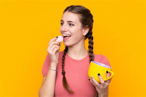 Premium Photo Young Woman With Macarons Over Isolated Wall