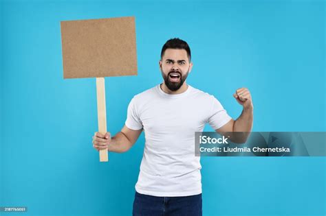 밝은 파란색 배경에 빈 표지판을 들고 화난 남자 텍스트를 위한 공간 25 29세에 대한 스톡 사진 및 기타 이미지 25 29세 Revolution 감정 Istock