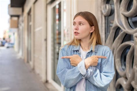 Premium Photo Looking Puzzled And Confused Insecure And Pointing In Opposite Directions With