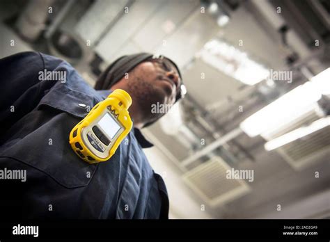 Portable Gas Detector Industrial Worker Wearing A Portable Gas Detector Used To Detect Gas