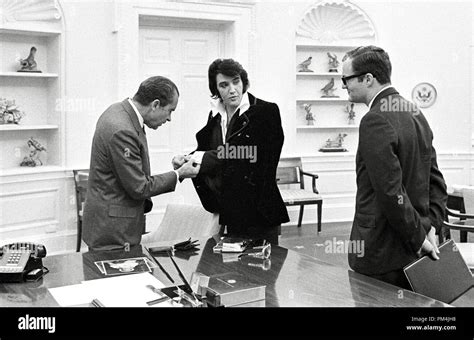 Elvis Presley Shows President Richard Nixon His Cuff Links December 21