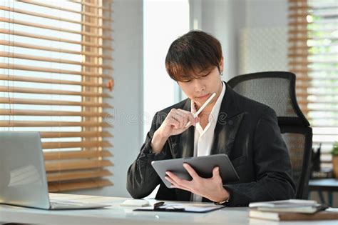 Image Of Financial Analyst In Elegant Suit Sitting At His Workstation And Analyzing Statistical