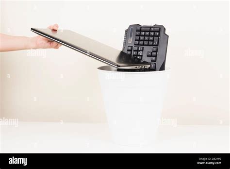Hand Puts Used Laptop Computer Into Recycling Bin Full Of Old Electronic Devices Planned