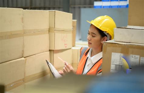 Premium Photo Female Warehouse Worker Counting Items In An Industrial Warehouse On The