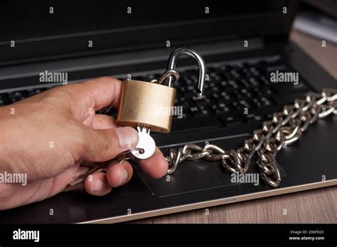 Unlocking The Padlock With Laptop In The Background Computer And Data Security Concept Stock