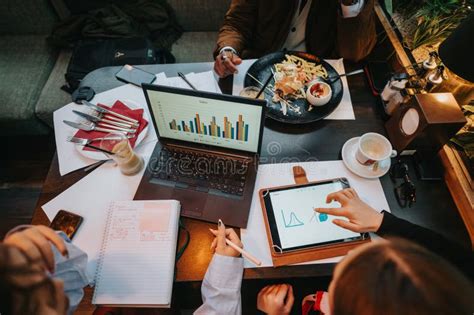 Collaboration And Data Analysis During A Business Strategy Meeting At A Cafe Stock Image Image