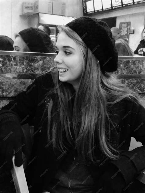 Premium Photo Smiling Teenage Girl Looking Away While Sitting Indoors