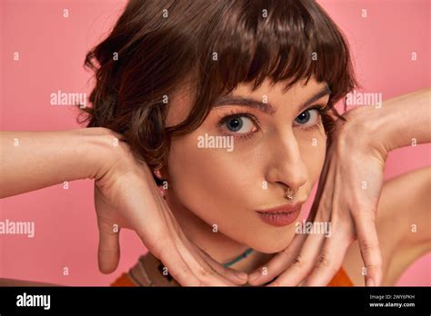 Flirty Young Woman With Nose Piercing And Short Brunette Hair Pouting