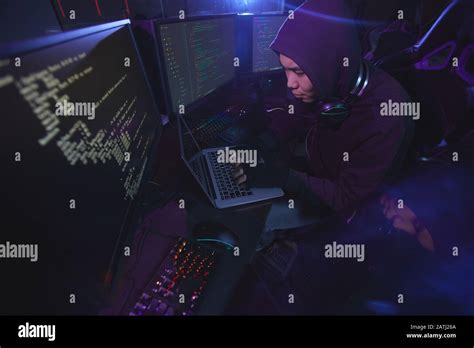 High Angle View At Asian Cyber Security Hacker Wearing Hood While