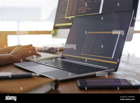 Background Image Of Male Hands Typing On Keyboard With Black And Orange Programming Code On