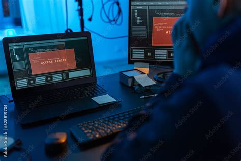 Cybercrime Hacking And Technology Concept Close Up Of Male Hacker In Dark Room Using Computer