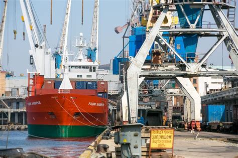 A Crane Performs Loading And Unloading Operations At The Seaport