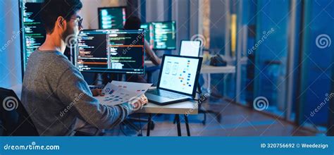 asian software developers working on multiple screens displaying code