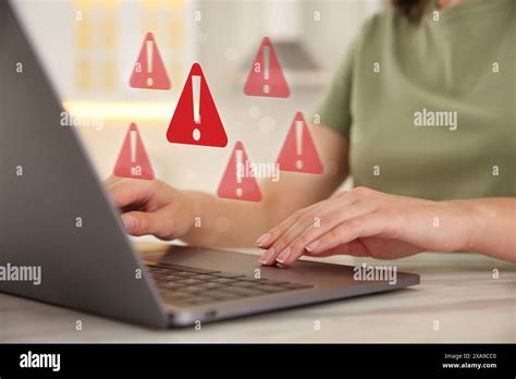 Woman Using Laptop At Table Closeup Warning Signs For Spam Messages