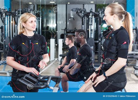 Two Nice Girls Dressed Ems Vests Talking In Gym Stock Image Image Of