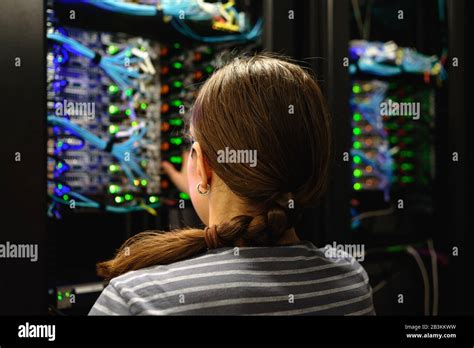 Woman Network Engineer Near Working Server Rack Data Center In Modern IT Company Stock Photo