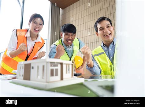 Engineers Celebrating Completion Of Sustainable Construction Model