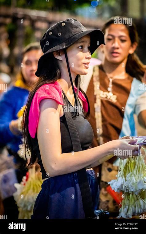 A Pretty Young Filipino Girl Sells Flower Garlands At Santo Nino De