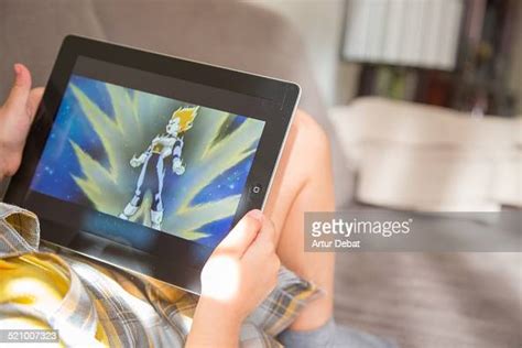 Girl Watching Cartoons Online With The Ipad Tablet Laying In The Sofa