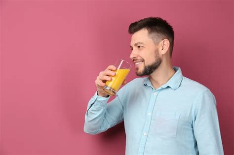 Premium Photo Handsome Man Drinking Orange Juice
