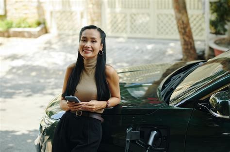 Premium Photo Vietnamese Woman Standing At Hybrid Car