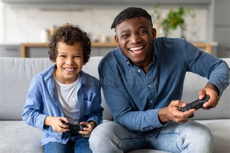 Father And Son Laughing While Playing Video Games Stock Image Image Of Leisure Cheerful