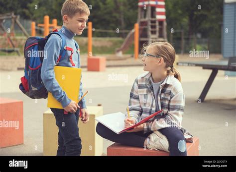 Male And Female Classmates Studying In The Babe Yard After Classes Stock Photo Alamy